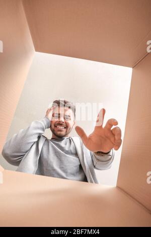 portrait of a man unpacking things from boxes in the room Lifestyle ...