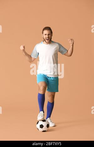Happy emotional football player on white background Stock Photo - Alamy