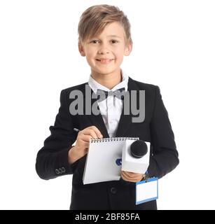 Little journalist with microphone and notebook on light color ...