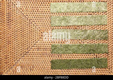 Tasty seaweed sheets on wicker mat Stock Photo - Alamy