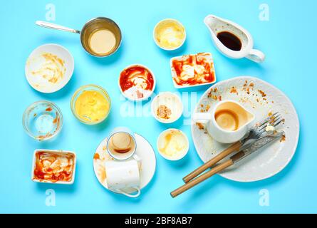 Dirty empty dishes on color background Stock Photo - Alamy