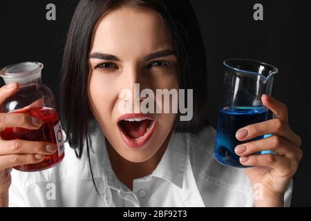 Female alchemist with potions on dark background Stock Photo - Alamy