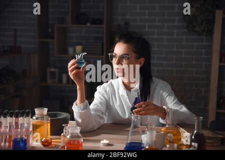 Female alchemist working in laboratory Stock Photo - Alamy