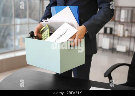 Fired worker with personal things in office Stock Photo - Alamy