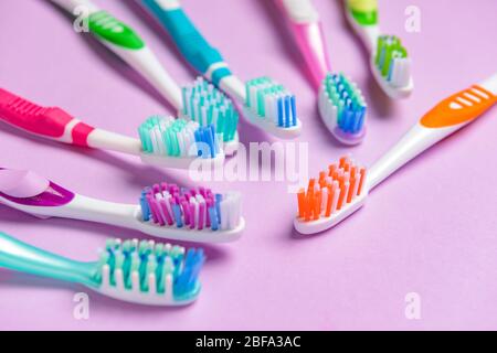 Tooth brushes on color background Stock Photo - Alamy