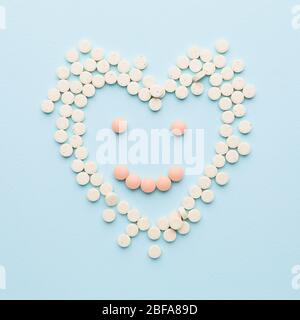 Smile made of pills on color background Stock Photo - Alamy