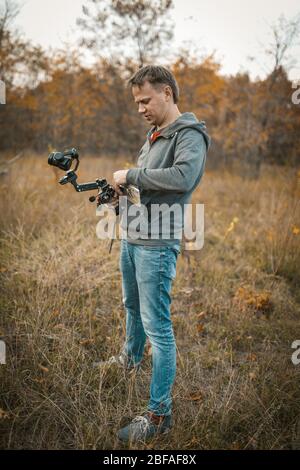 Cameraman outdoors. Photographer shooting nature. Creating memories for ...