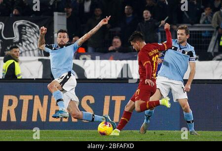 Cengiz Under of AS Roma is challenged by Senad Lulic of SS Lazio during ...
