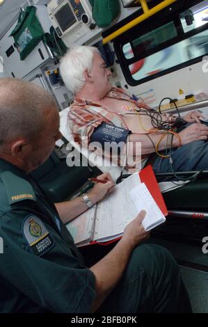 Paramedic taking notes from patient.(MODEL RELEASED Stock Photo - Alamy