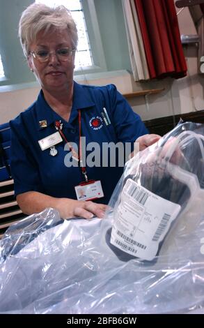A NHS National Blood Service packs donated blood into storage bags ...