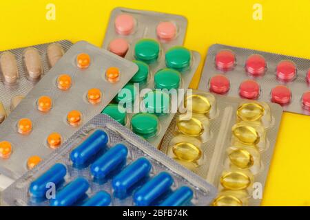 group of multi-colored pharmaceutical medication and medicine pills in ...