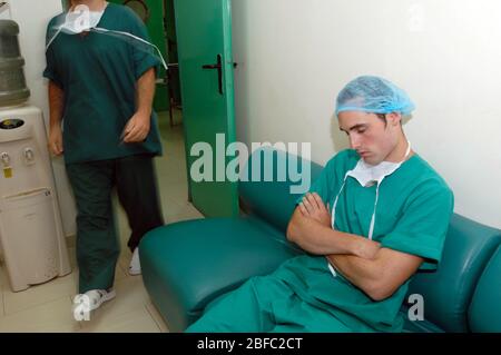 A tired surgeon sleeps in the staff waiting room (MODEL RELEASED Stock ...