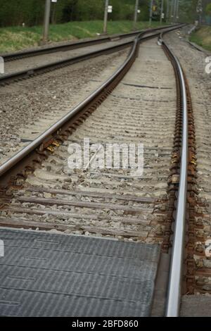 junction of two railway tracks merging into the same path Stock Photo ...