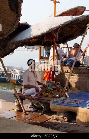 INDIA. BENARES. PANDIT (HINDU PRIEST) READING THE SCRIPTURES IN THE ...