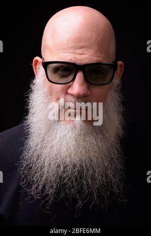 Handsome bearded man with hair or bald senior in barbershop. Two ...