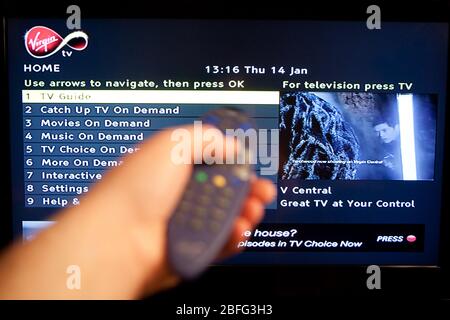 A man browsing the Virgin Media cable television menus and On Demand ...