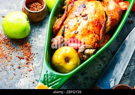 Appetizing baked chicken with apples in baking dish Stock Photo - Alamy
