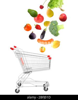 Groceries falling into shopping cart on white background Stock Photo ...