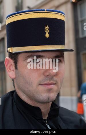 Man in a French gendarme uniform pointing at a blank board ready for ...