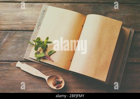Open recipe book with mint leaves on wooden background Stock Photo - Alamy