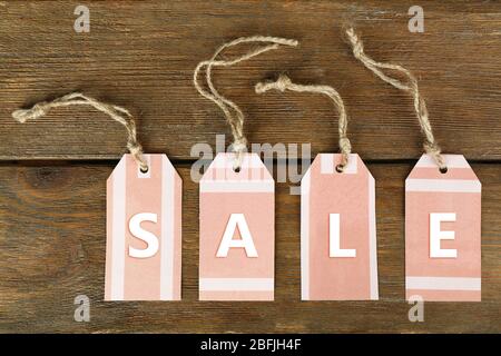 Sale tags on wooden background Stock Photo - Alamy