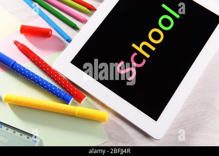 Tablet PC with colorful markers on desktop background Stock Photo - Alamy