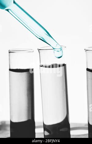 Dropper and test tubes, close up, isolated on white Stock Photo - Alamy