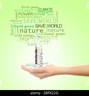 Concept of environmental protection, words in tree shape in hands ...