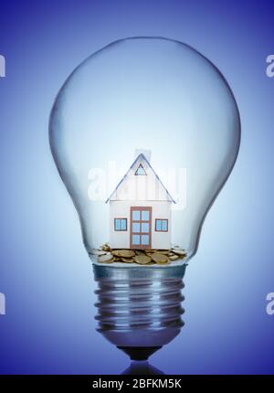 House symbol inside glass lightbulb Stock Photo - Alamy
