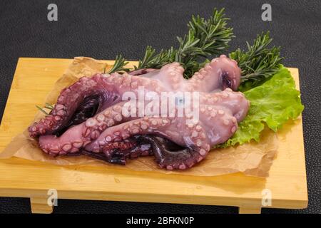 Raw octopus ready for cooking with rosemary Stock Photo - Alamy