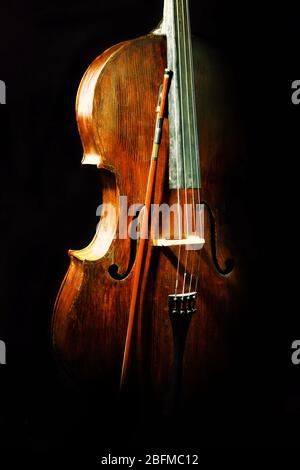 Vintage cello on dark background Stock Photo - Alamy