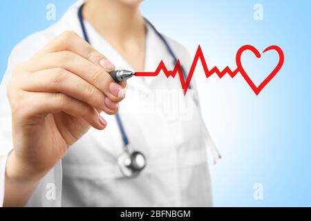 Cardiologist drawing heart, closeup. Cardiology concept Stock Photo - Alamy