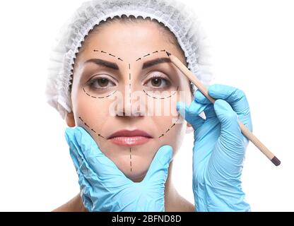 Surgeon drawing marks on female body before plastic operation, white ...