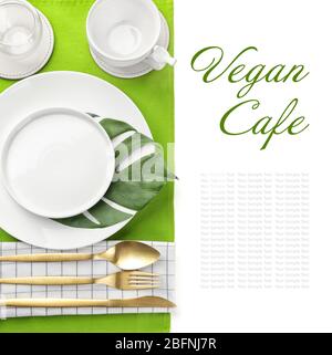 Table setting and text VEGAN CAFE on white background Stock Photo - Alamy