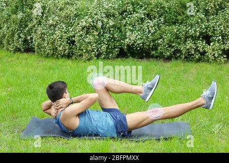 Young man doing bicycle crunch exercise on white background Stock Photo ...