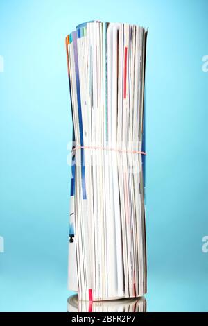Rolled up magazines on gray background Stock Photo - Alamy