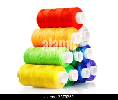 Pyramid of many-coloured bobbins of thread isolated on white Stock ...