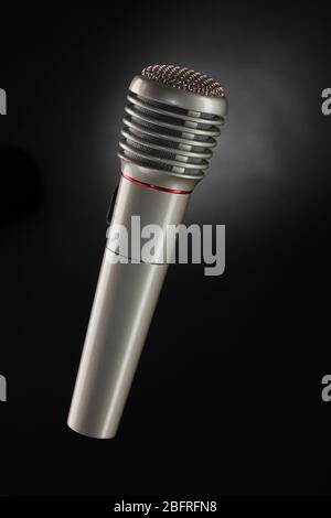 Shiny grey iron microphone on black background Stock Photo - Alamy