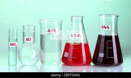 Test-tubes with various acids on blue background Stock Photo - Alamy
