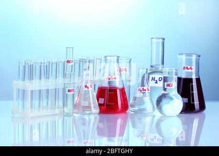 Test-tubes with various acids on blue background Stock Photo - Alamy