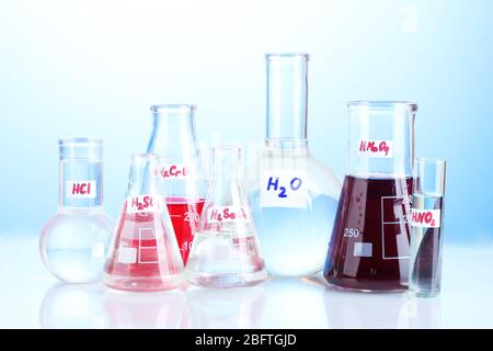 Test-tubes with various acids on blue background Stock Photo - Alamy