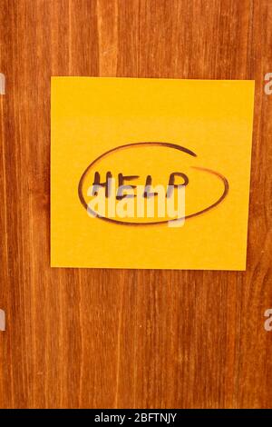 Help written on sticker on wooden background Stock Photo - Alamy