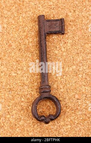 Antique key on cork background Stock Photo - Alamy