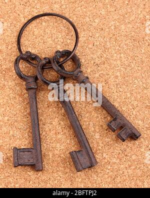 a bunch of antique keys on cork background Stock Photo - Alamy