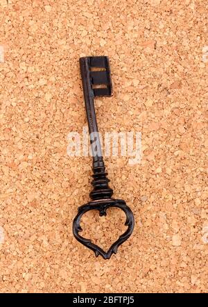 Antique key on cork background Stock Photo - Alamy