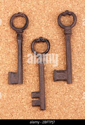 a bunch of antique keys on cork background Stock Photo - Alamy