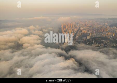 Aerial photo shows the spectacular sunrise over snow-covered mountains ...