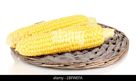 Fresh corn cobs on wicker mat isolated on white Stock Photo - Alamy