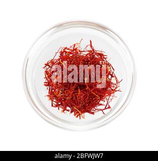 stigmas of saffron in transparent bowl isolated on white background ...