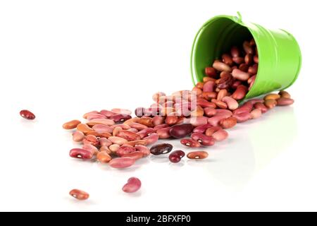 Brown beans in green bucket isolated on white Stock Photo - Alamy